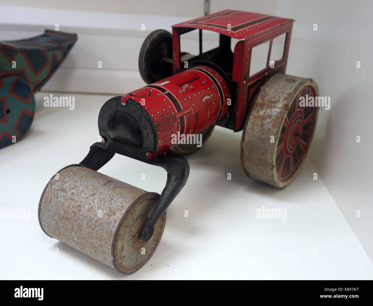 A classic tin toy roller from the past, photographed in the first image ...