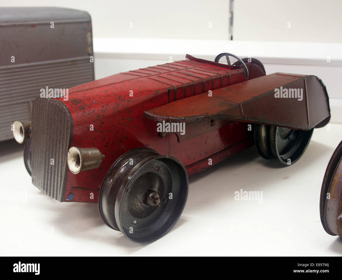This image features an old tin toy car, capturing the vintage ...