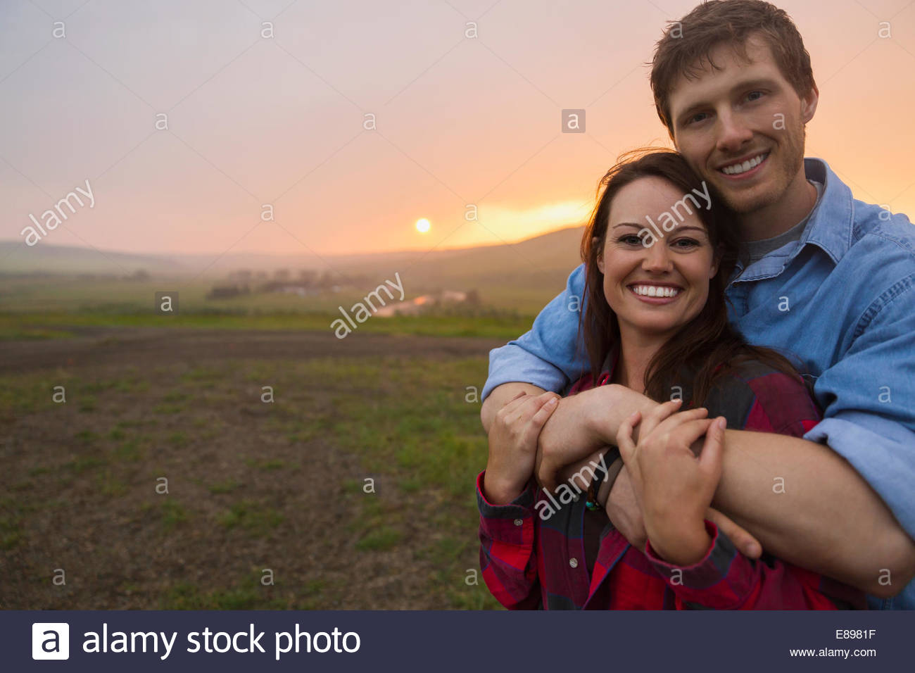 Couple hugging in field hi-res stock photography and images - Alamy