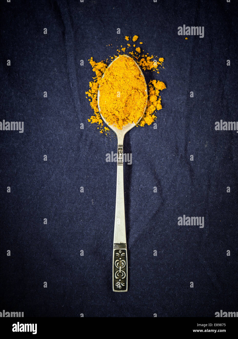 Turmeric powder in a spoon on a dark background Stock Photo - Alamy