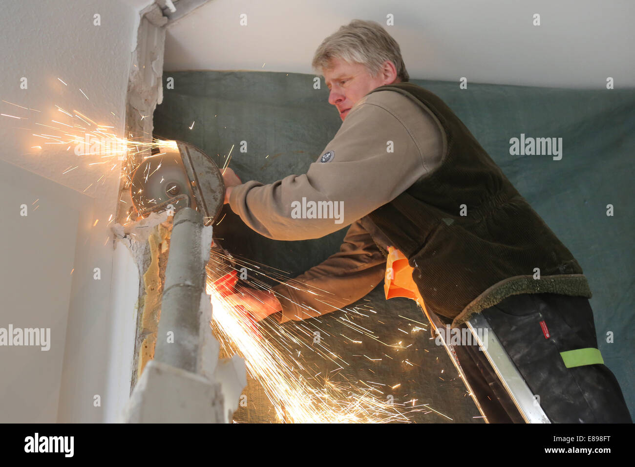 Berlin, Germany, craftsmen worked a wall with an angle grinder Stock ...