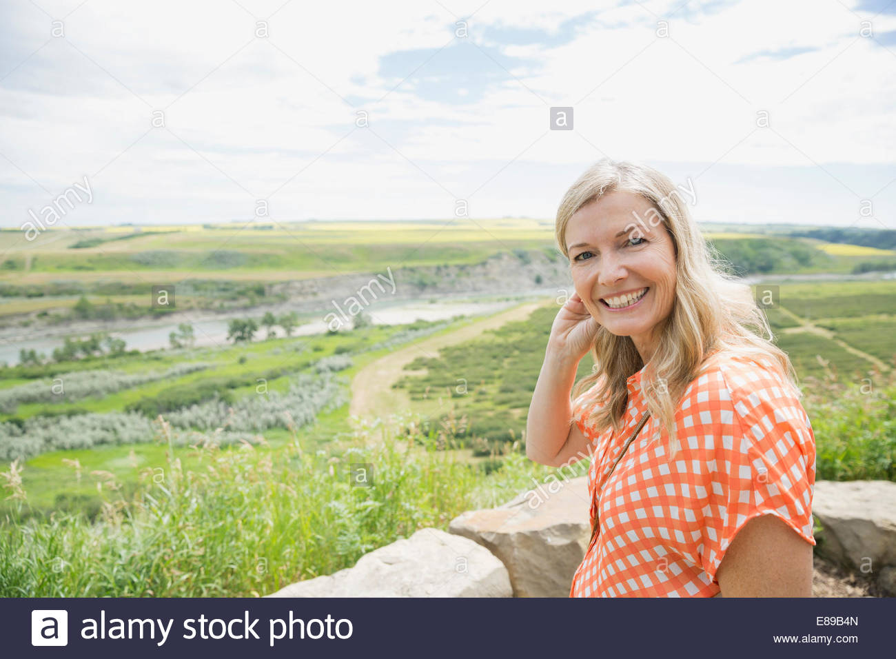 Portrait of smiling woman with countryside in background Stock Photo ...