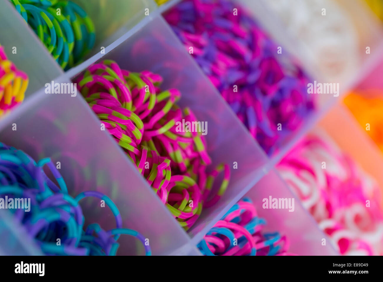 Brightly coloured loom bands in a box Stock Photo - Alamy