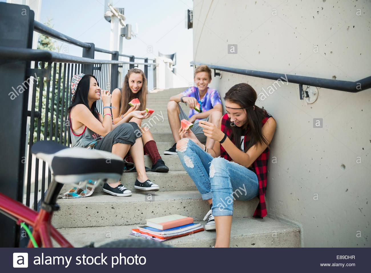 Teenagers eating watermelon on stairs Stock Photo - Alamy