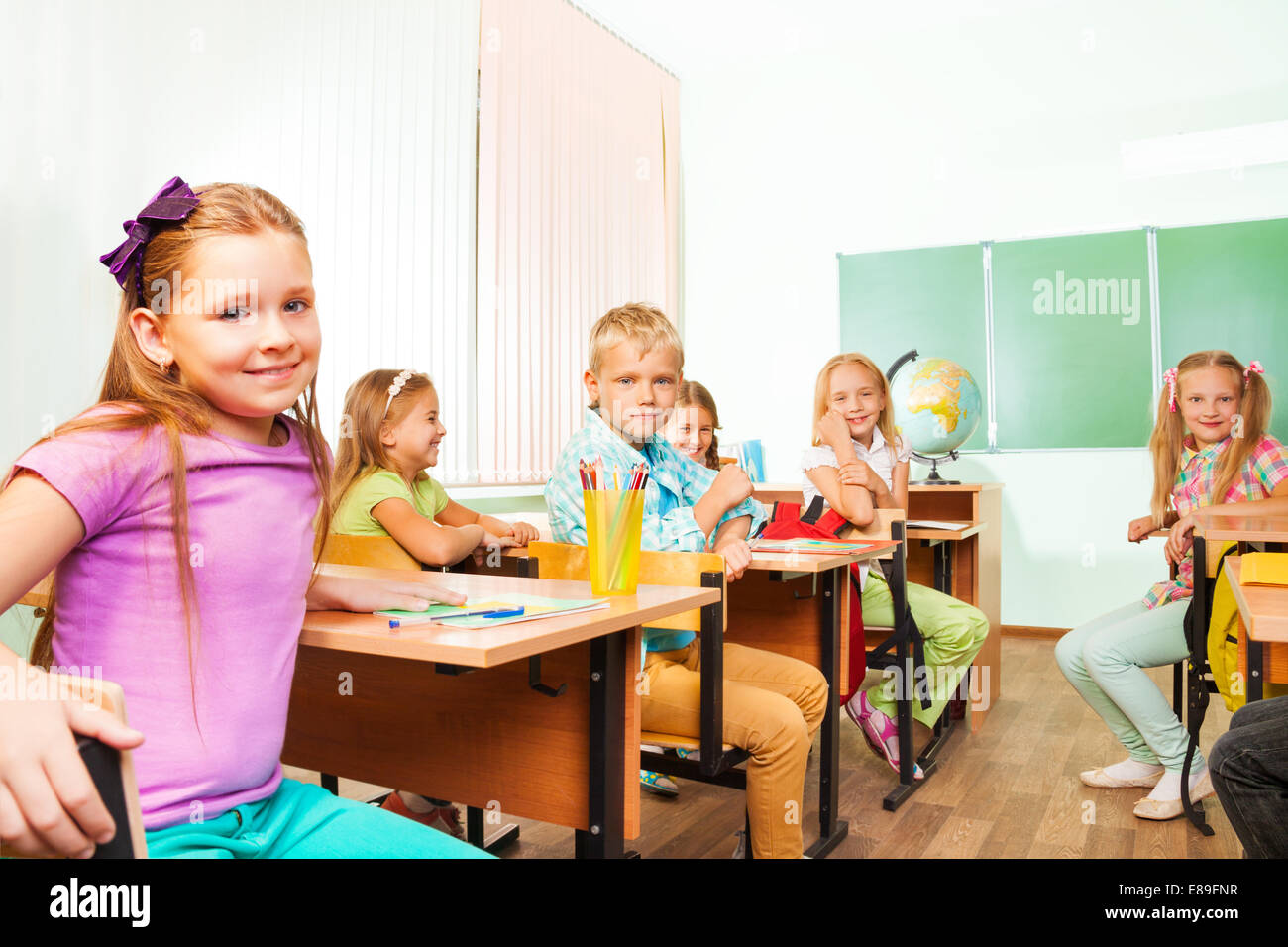 School kids sitting at studying desks in class Stock Photo - Alamy