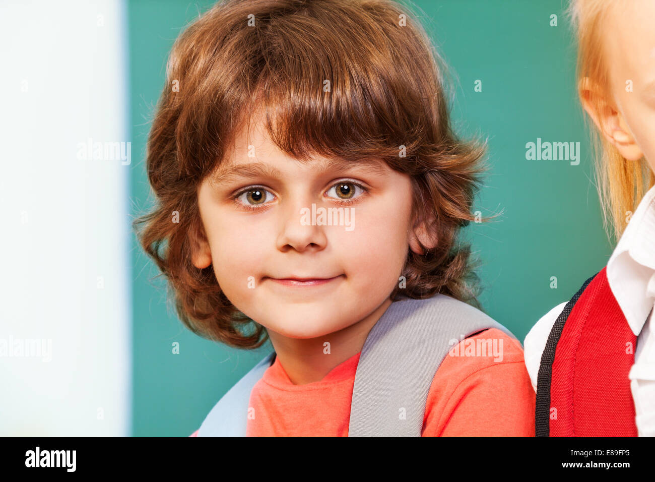 Portrait of cute schoolboy looking straight Stock Photo - Alamy
