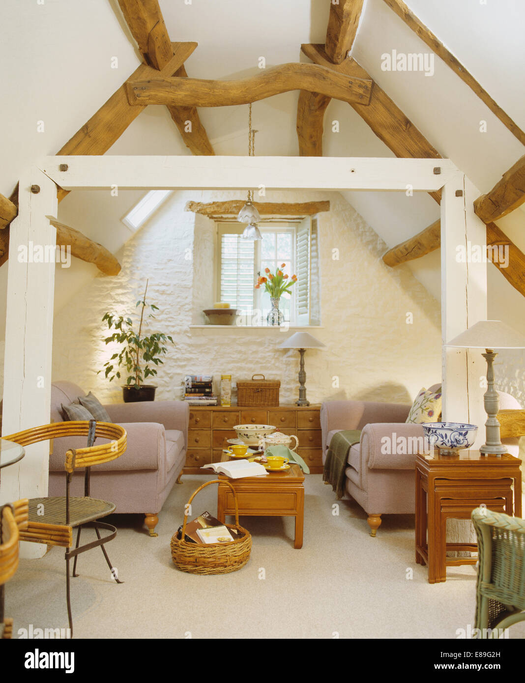 Old oak beams and white painted support beam in country loft living ...
