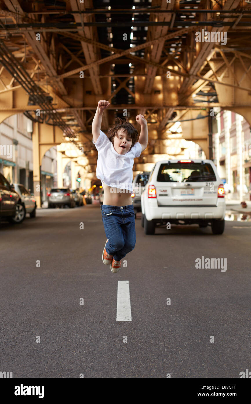 Boy jumping in the street Stock Photo - Alamy