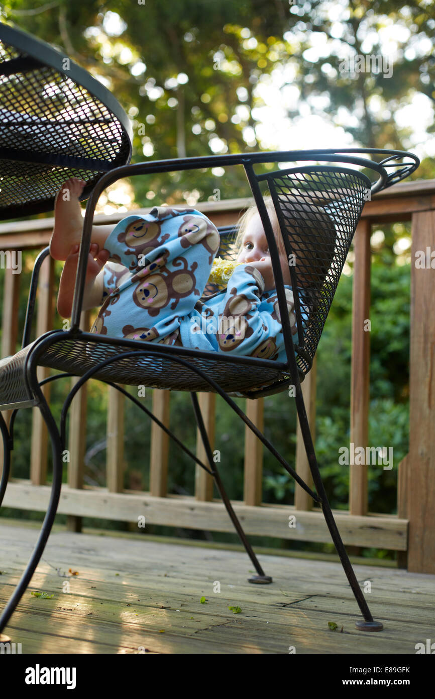 Child resting on chair on deck Stock Photo - Alamy