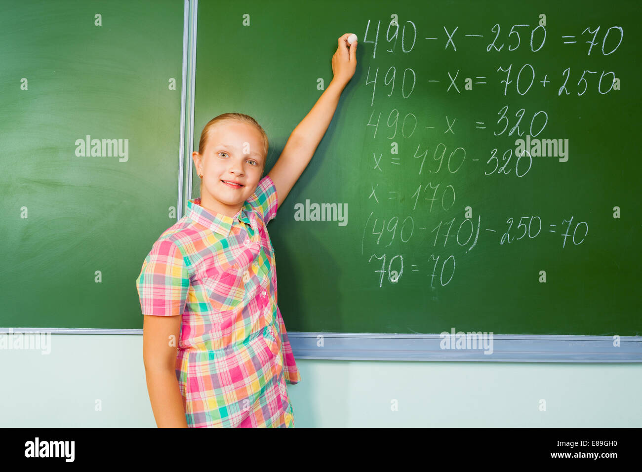 Girl with chalk writing mathematics equation Stock Photo - Alamy