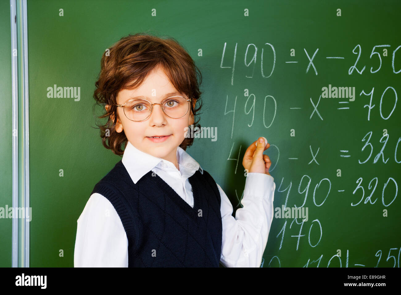 Clever Boy Holds Chalk Near Blackboard Stock Photo Alamy Clever Boy Holds Chalk Near Blackboard Stock Photo Alamy