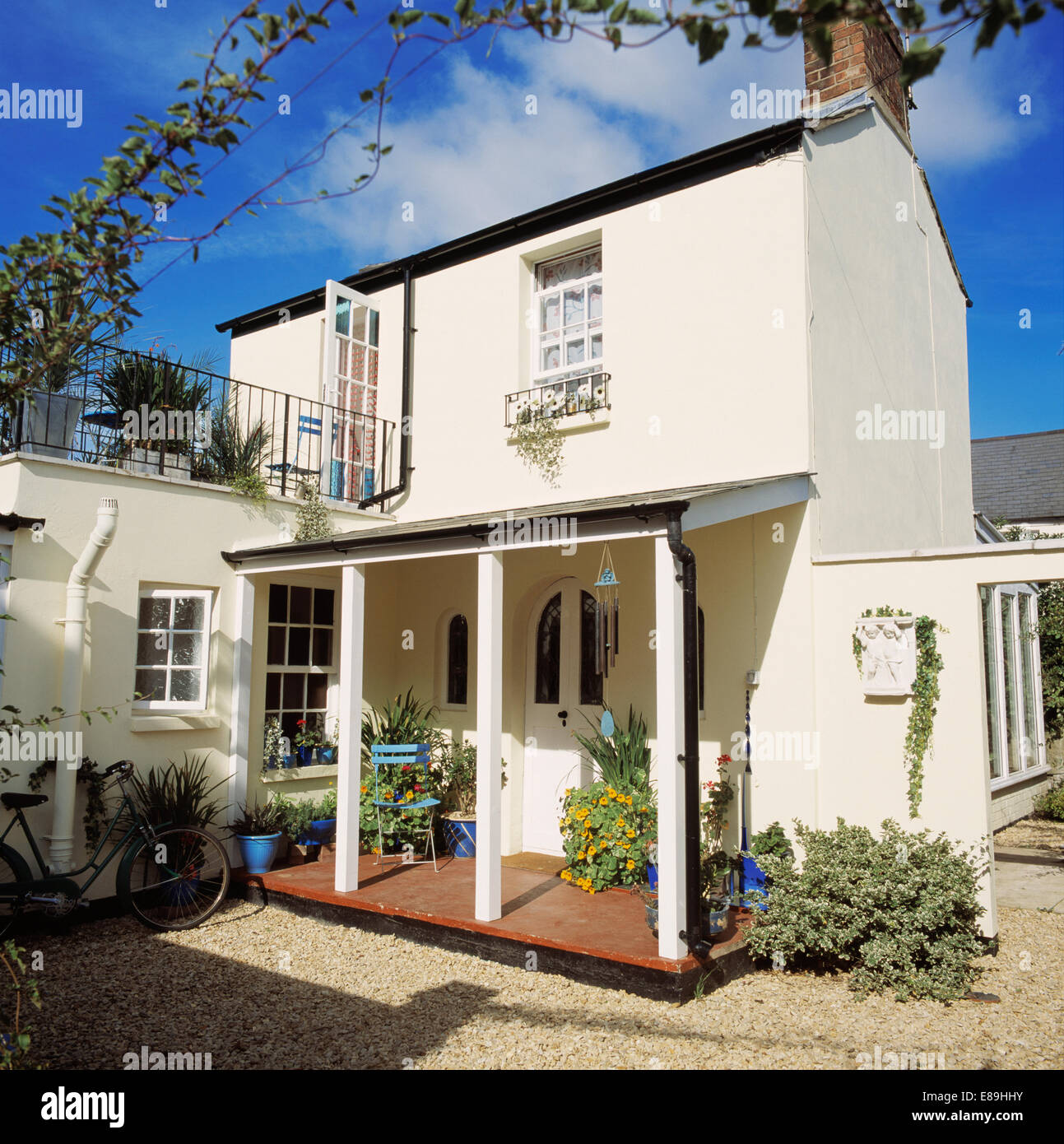 Newly painted townhouse with roof garden and sunny veranda with plants ...