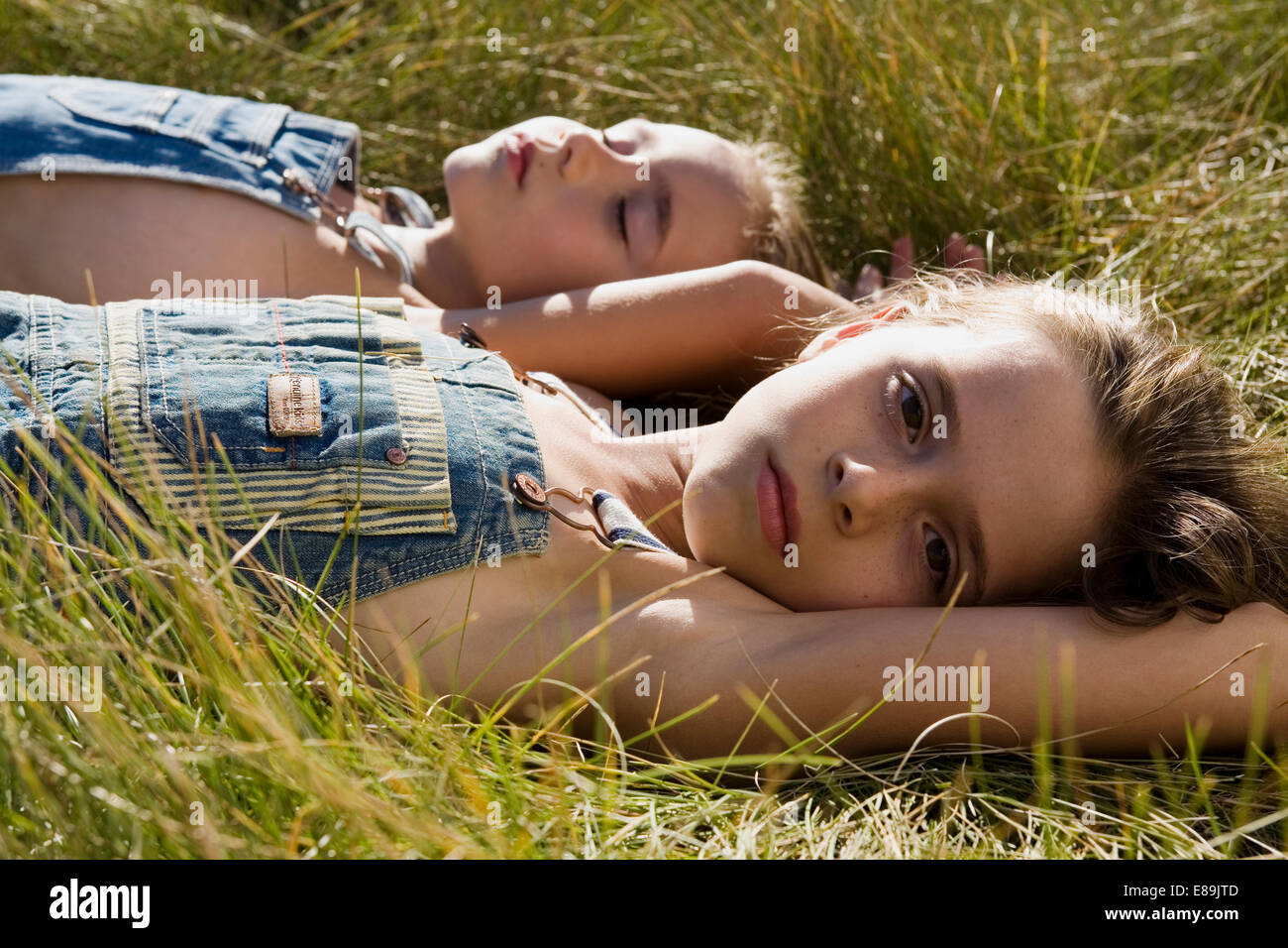 Two girls laying in grass hi-res stock photography and images - Alamy
