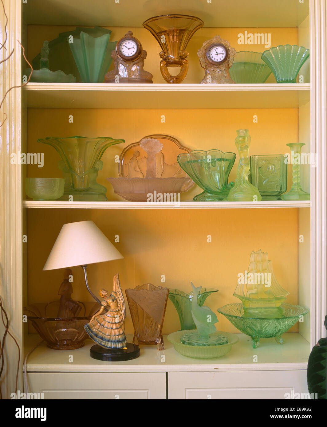 Close-up of collection of green glass on shelves Stock Photo - Alamy