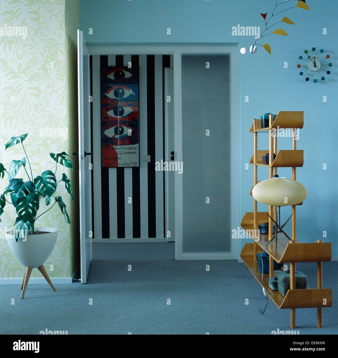 Pale wood freestanding fifties-style shelf unit and pale grey carpet in ...