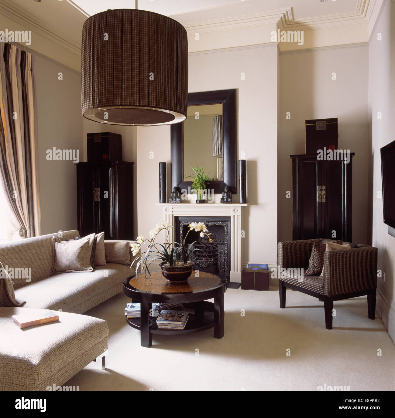 Wicker shade on ceiling late in beige townhouse living room with beige ...