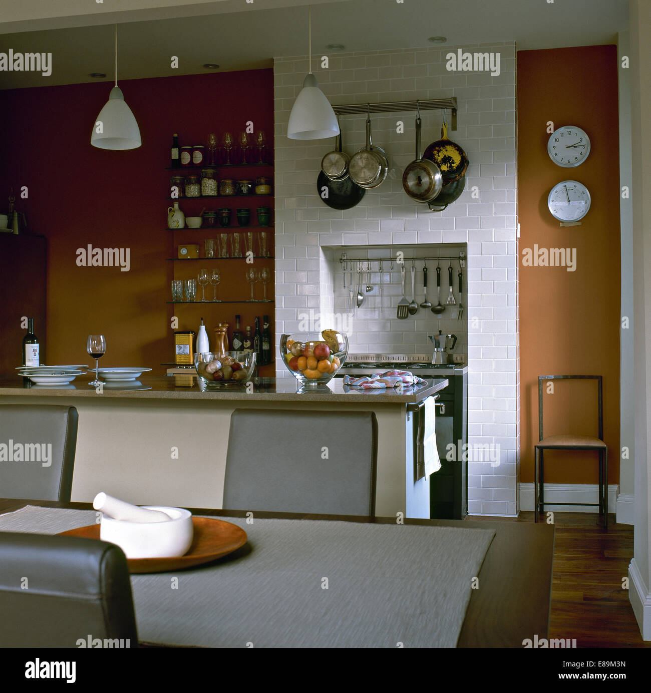 Dining table in modern kitchen with island unit Stock Photo - Alamy