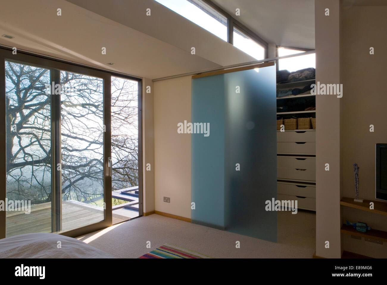 Modern bedroom with sliding glass screen separating dressing room Stock ...