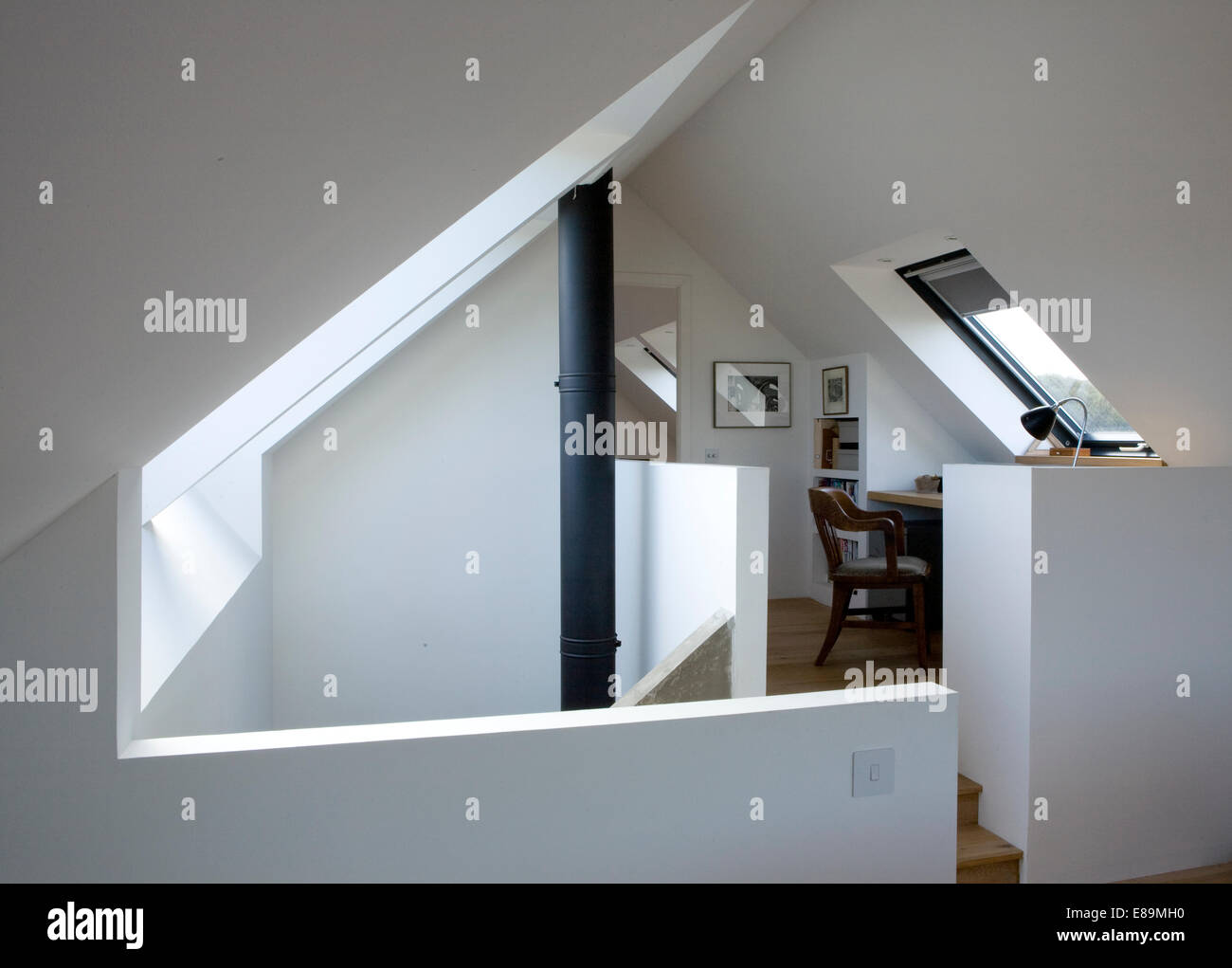 Modern home office area in roof space with Velux window Stock Photo - Alamy
