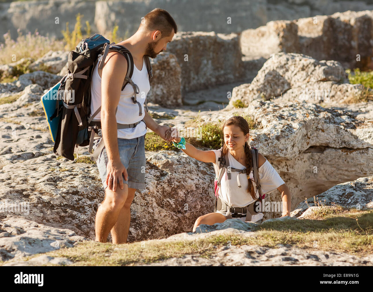 Travelling helps to get another tourist on mountain Stock Photo - Alamy