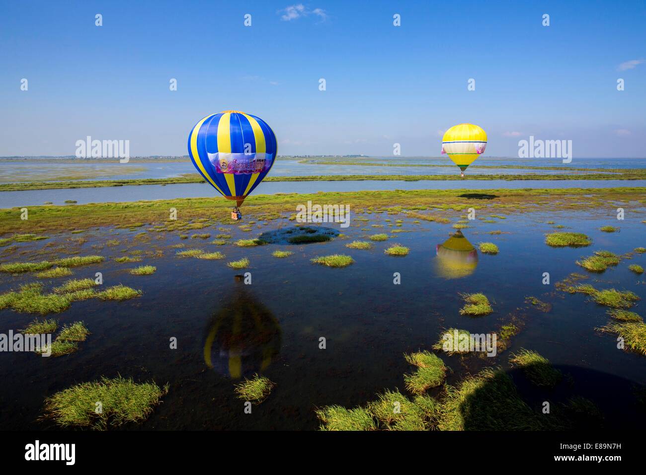 Jiujiang. 20th Sep, 2014. Hot air balloons fly over the Boyang Lake in ...