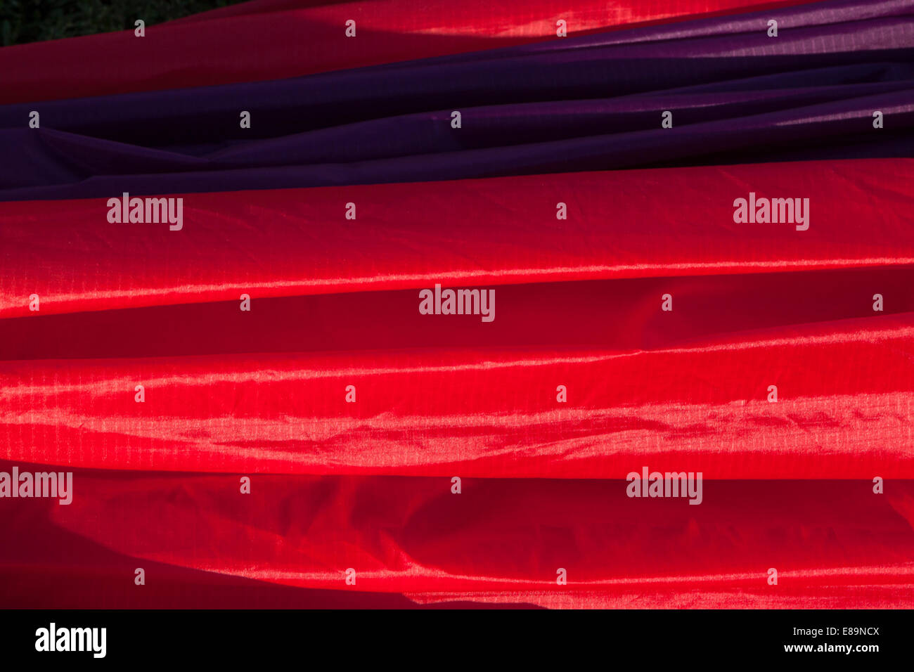 Closeup of nylon fabric of a hot-air balloon being prepared for storage ...