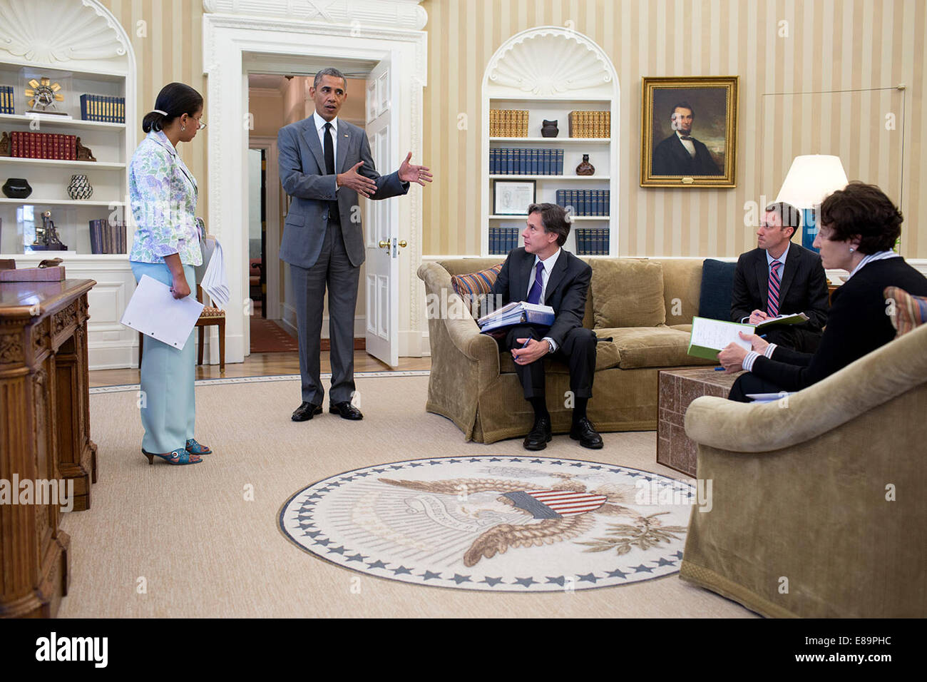 President Barack Obama speaks with advisors following a phone call with ...