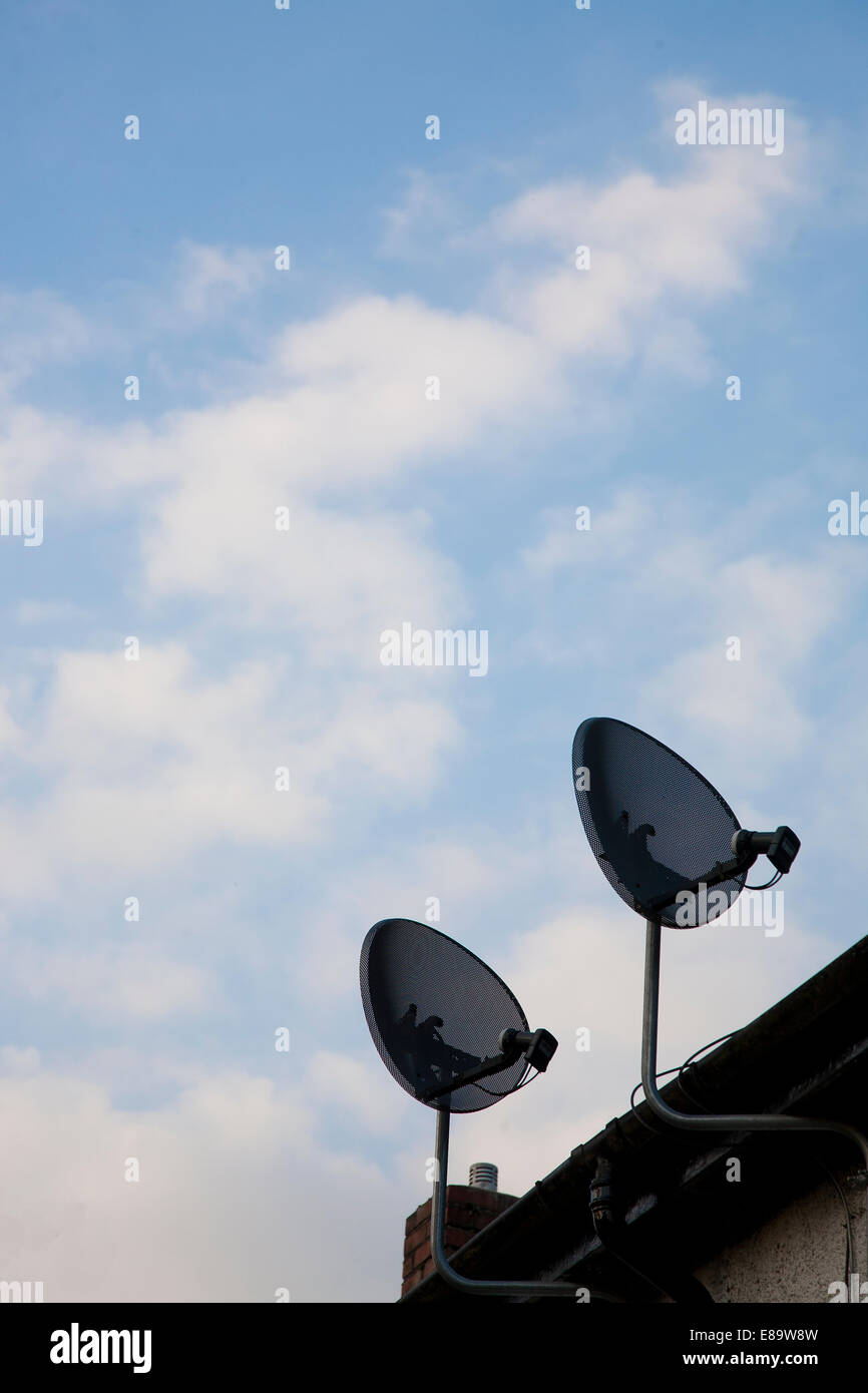 Satellite dish's on a rooftop with clouds in the background Stock Photo ...