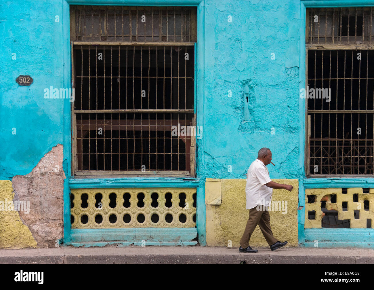Man walking past building hi-res stock photography and images - Alamy