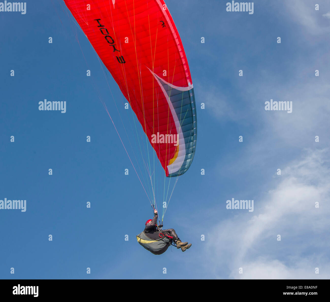 sky diver paraglider in clear blue sky with red kite and another with ...