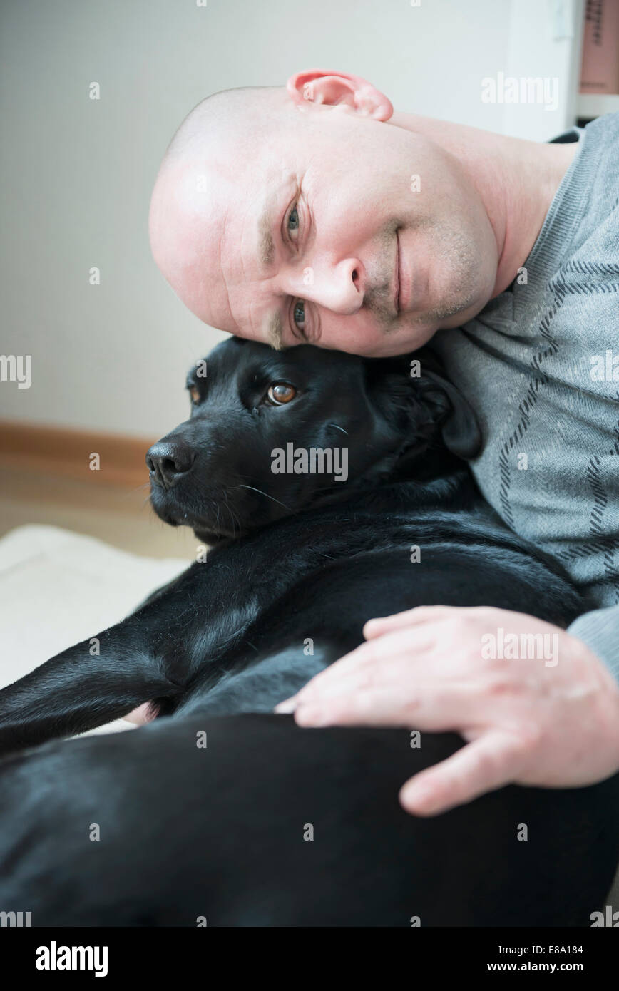 Portrait of man with his dog, smiling Stock Photo - Alamy