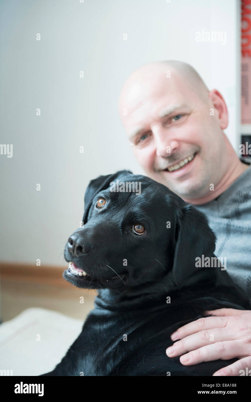 Portrait of man with his dog, smiling Stock Photo - Alamy