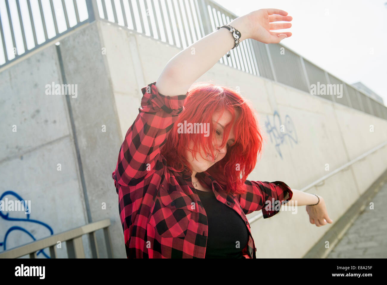 Young teenage girl dancing red dyed hair Stock Photo - Alamy