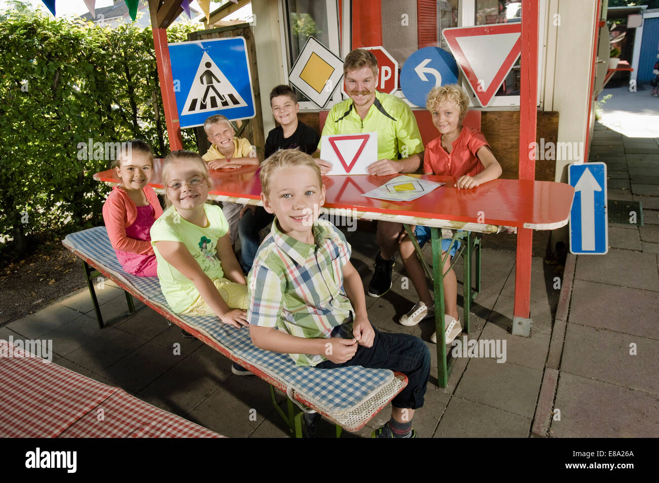 Children and young man at driver training area Stock Photo - Alamy