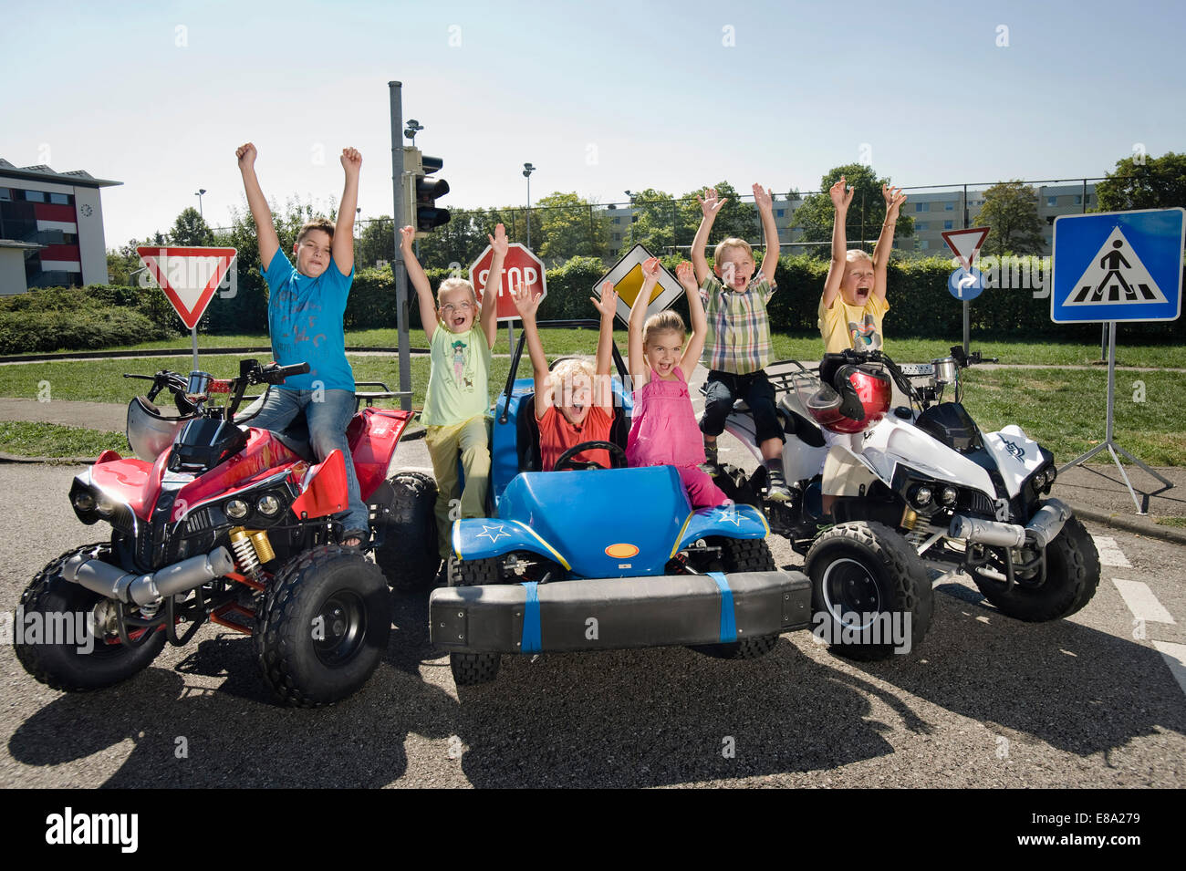 Excited children on driver training area Stock Photo - Alamy