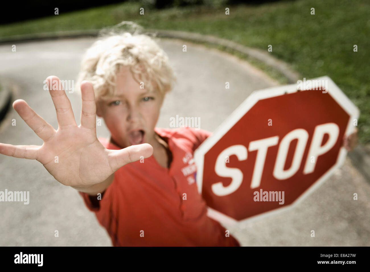 Boy on driver training area holding stop sign Stock Photo - Alamy