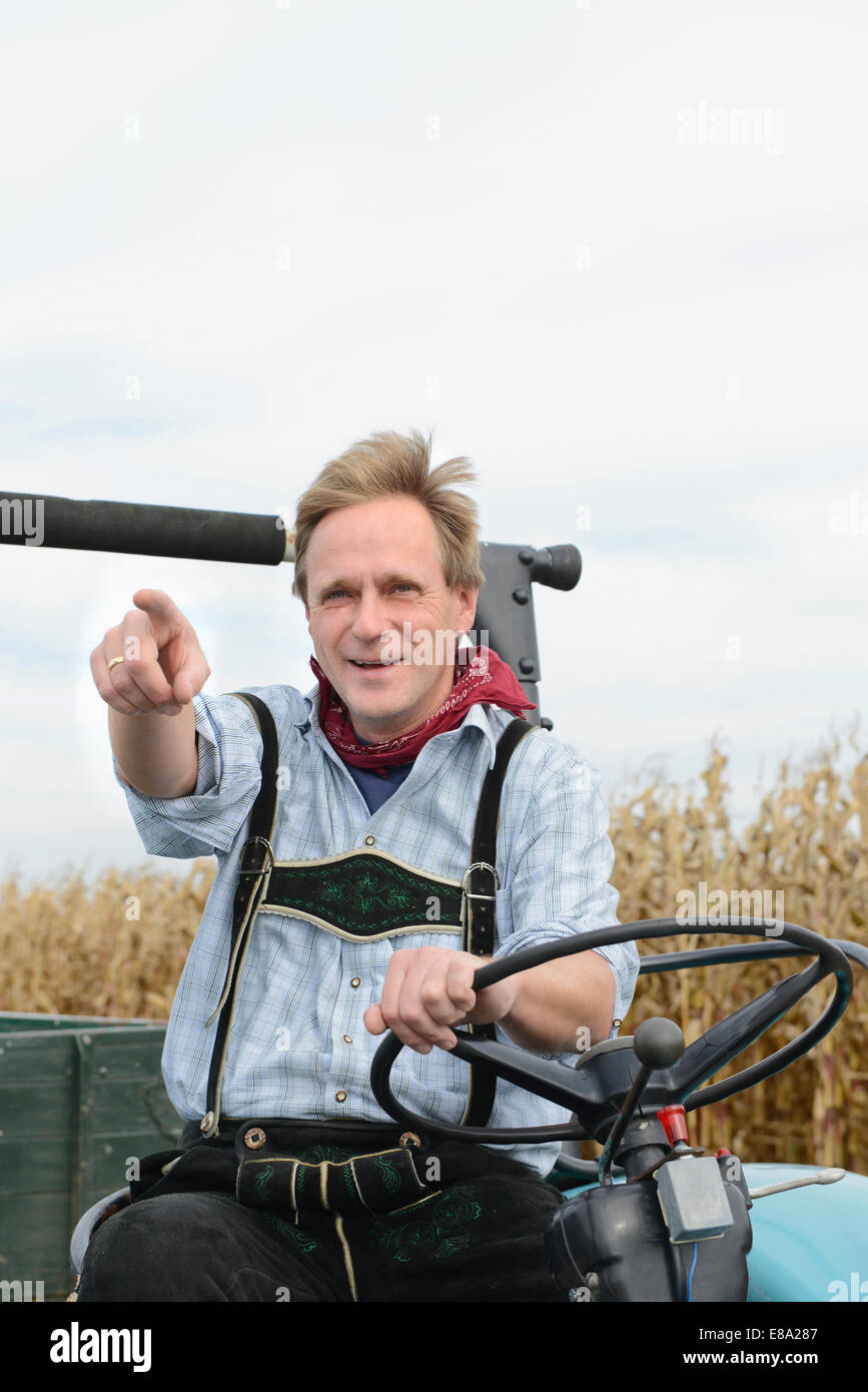 Farmer on his tractor on cornfield hi-res stock photography and images ...