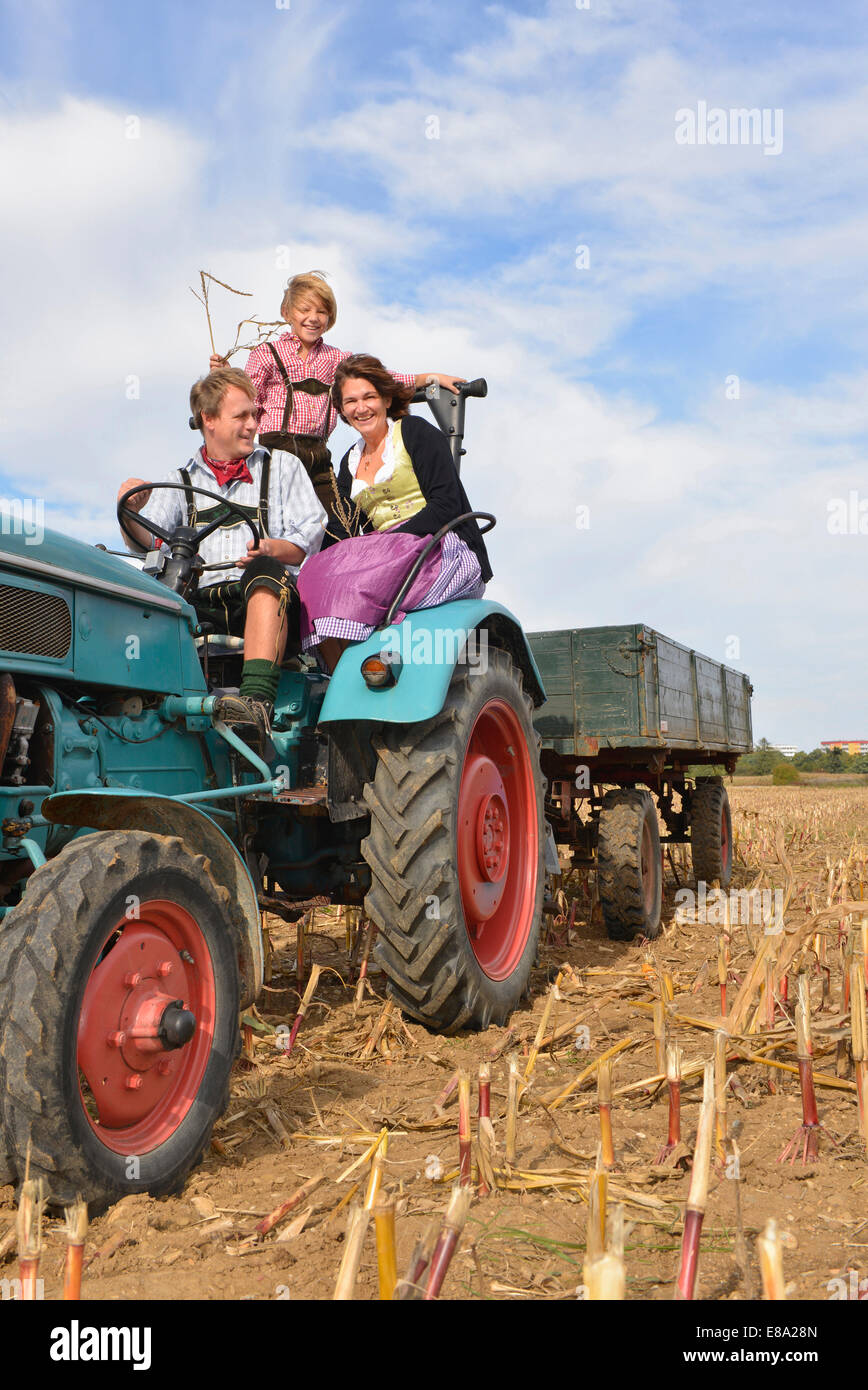 Family on tractor in cornfield, Bavaria, Germany Stock Photo - Alamy