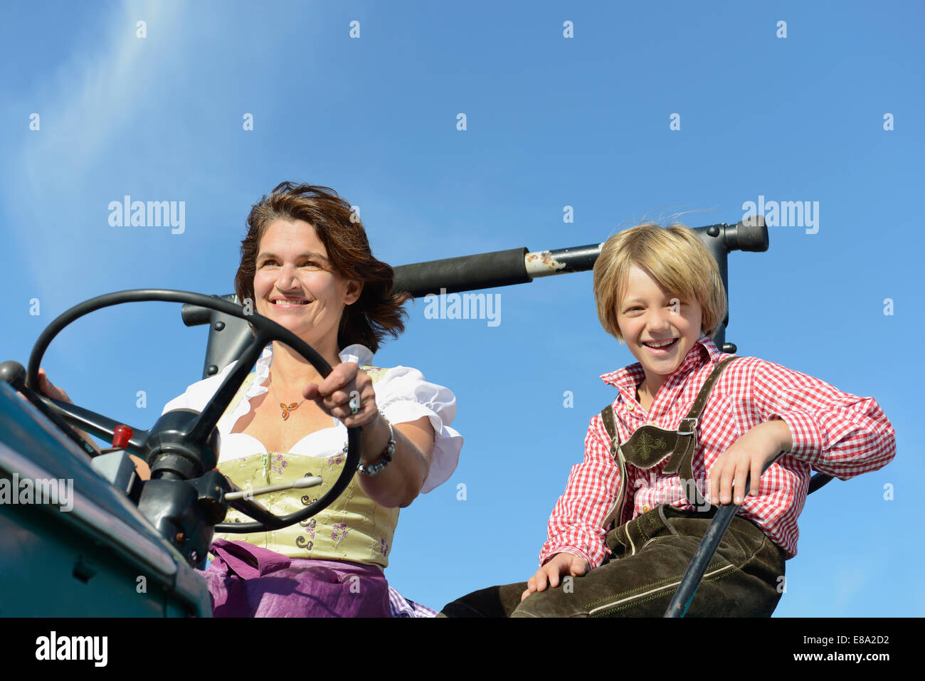 Mother and son driving tractor, Bavaria, Germany Stock Photo - Alamy