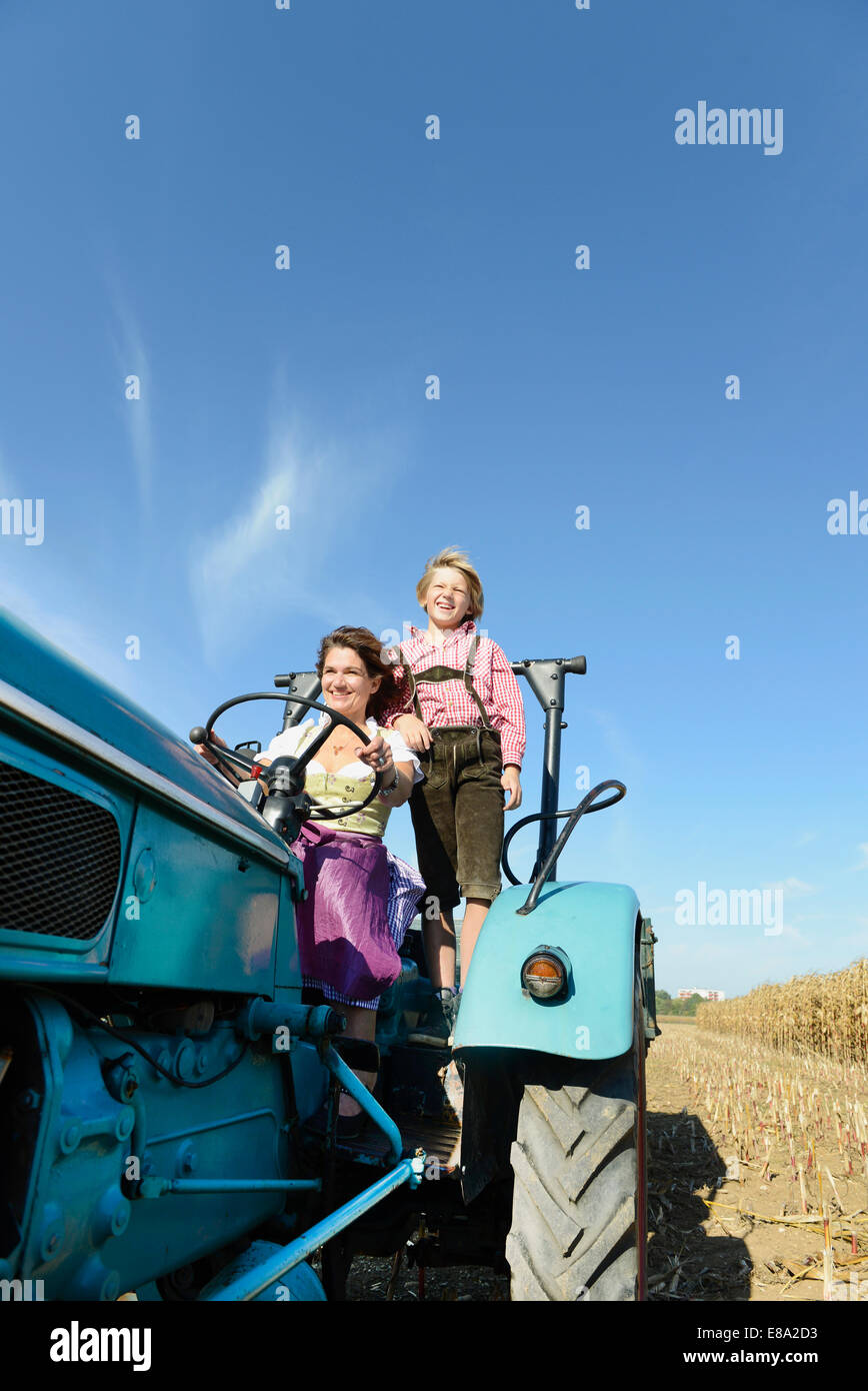Mother and son driving tractor, Bavaria, Germany Stock Photo - Alamy