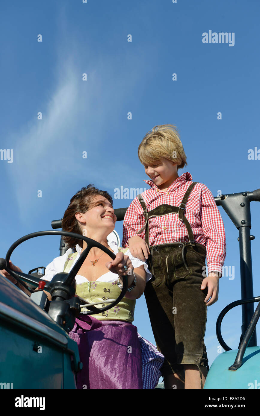 Mother and son driving tractor, Bavaria, Germany Stock Photo - Alamy