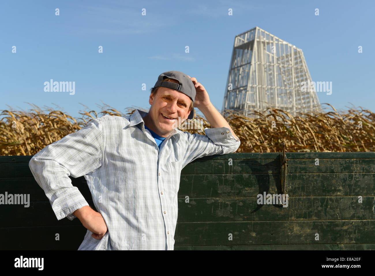 Farmer with tractor in his cornfield, geothermal power station in ... Farmer with tractor in his cornfield, geothermal power station in ...