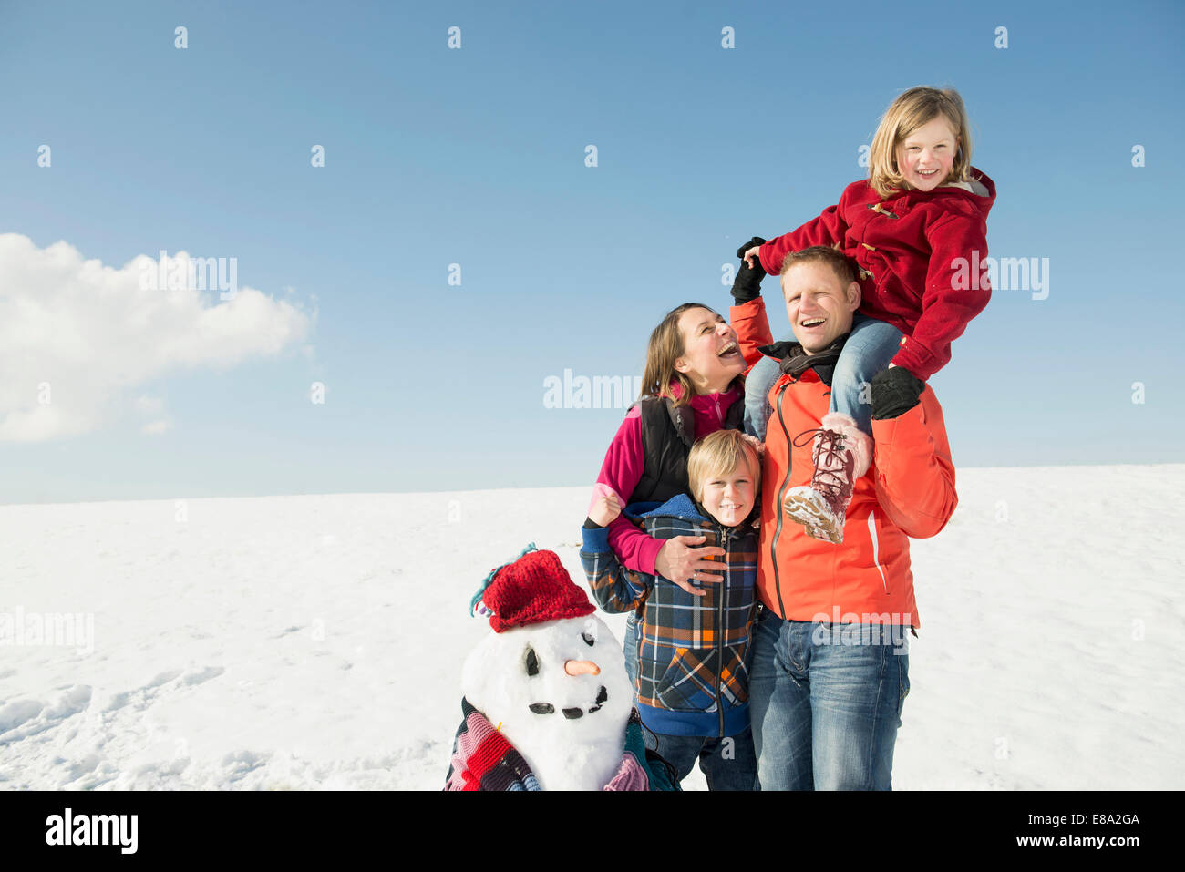 Family with snowman, smiling, Bavaria, Germany Stock Photo - Alamy