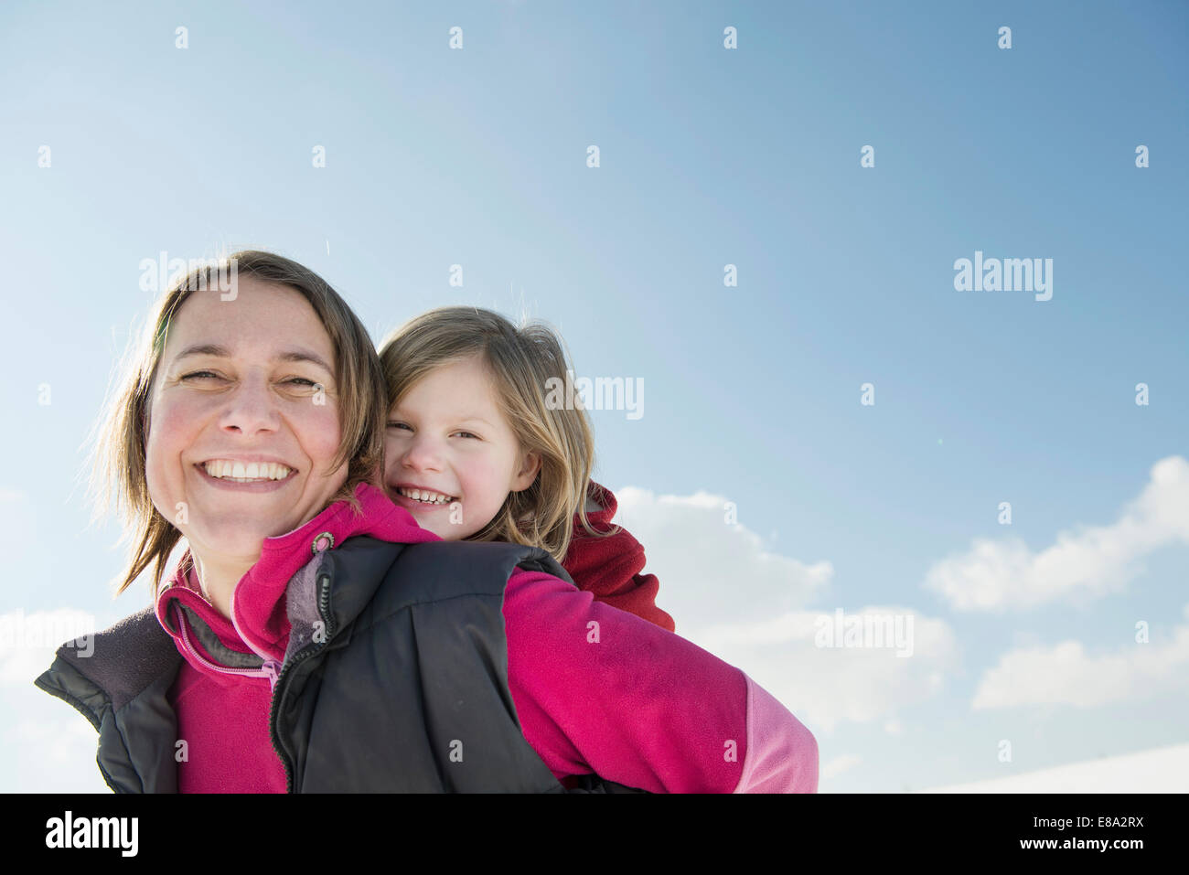 Mother giving piggyback ride to daughter, smiling, Bavaria, Germany ...