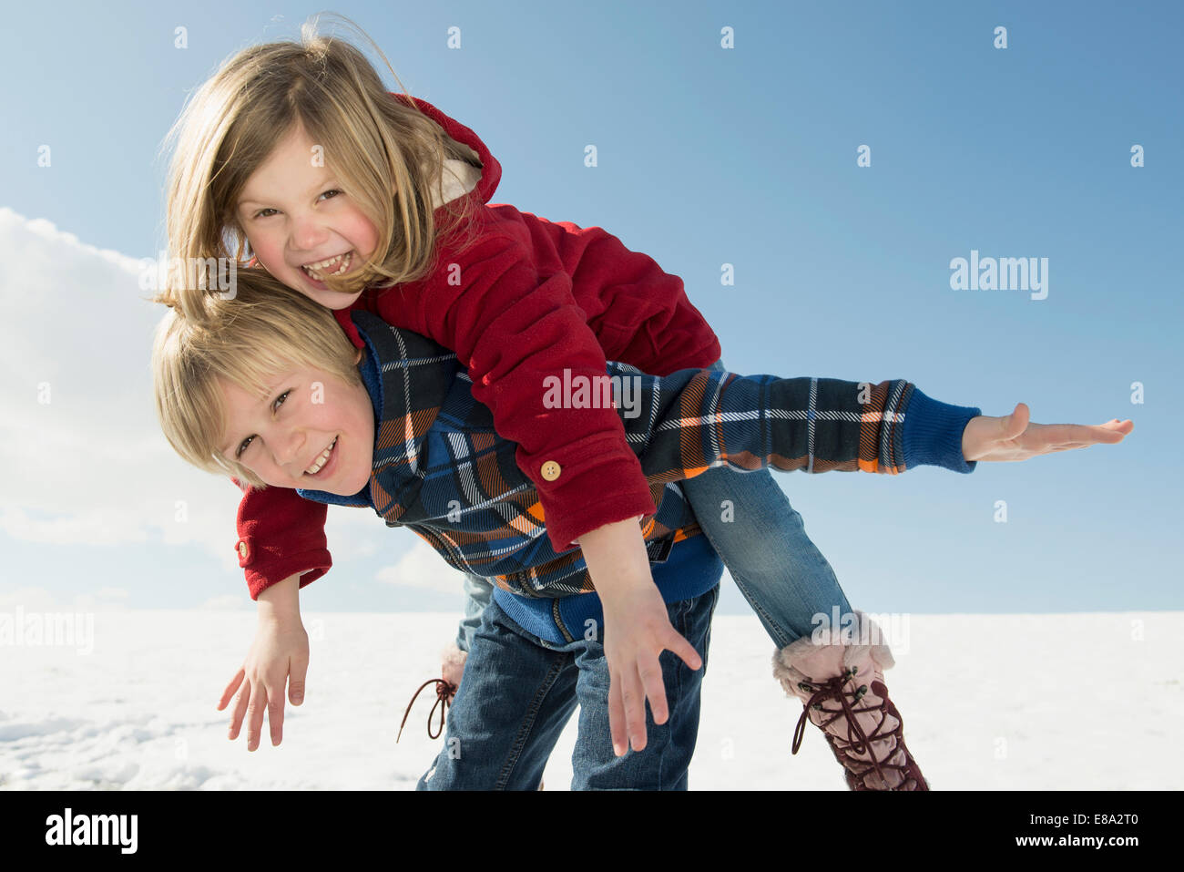 Girl giving piggy ride to boy hi-res stock photography and images - Alamy