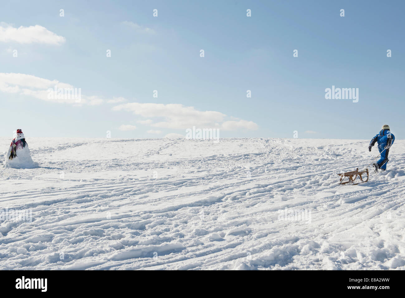Boy dragging sledge in snow, Bavaria, Germany Stock Photo - Alamy