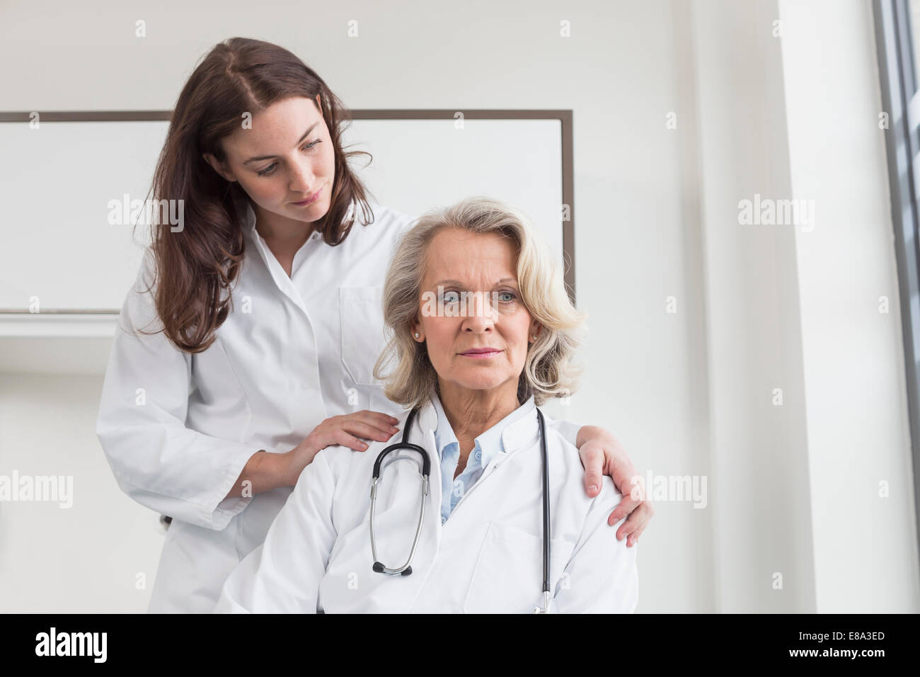 Doctor consoling stress women hi-res stock photography and images - Alamy