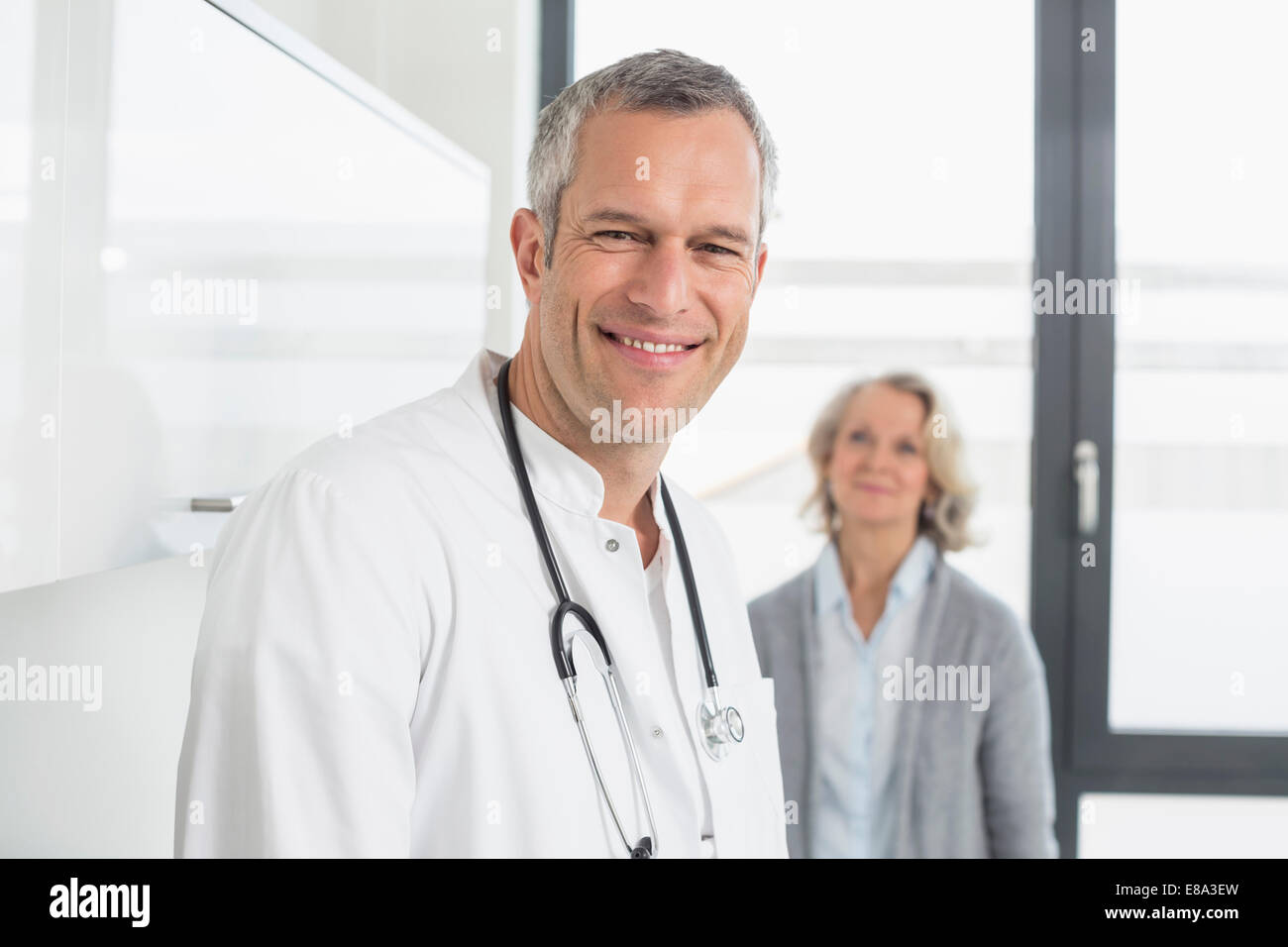 Doctor and patient, smiling Stock Photo - Alamy