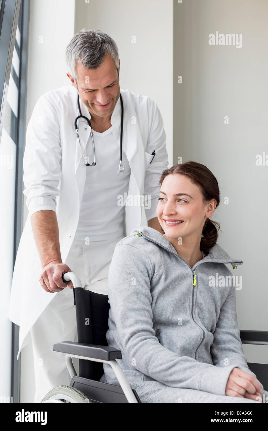 Doctor pushing patient in wheelchair hi-res stock photography and ...