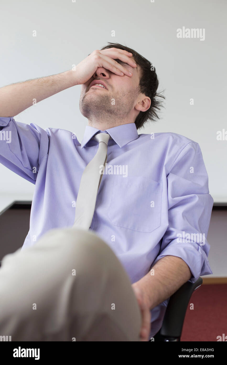 Stress businessman sitting in office Stock Photo - Alamy